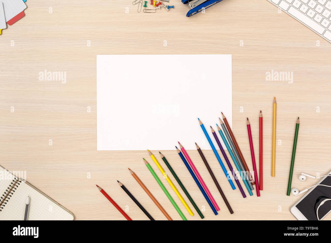 Wooden desk workplace top view nobody sheet of a4 paper and color ...