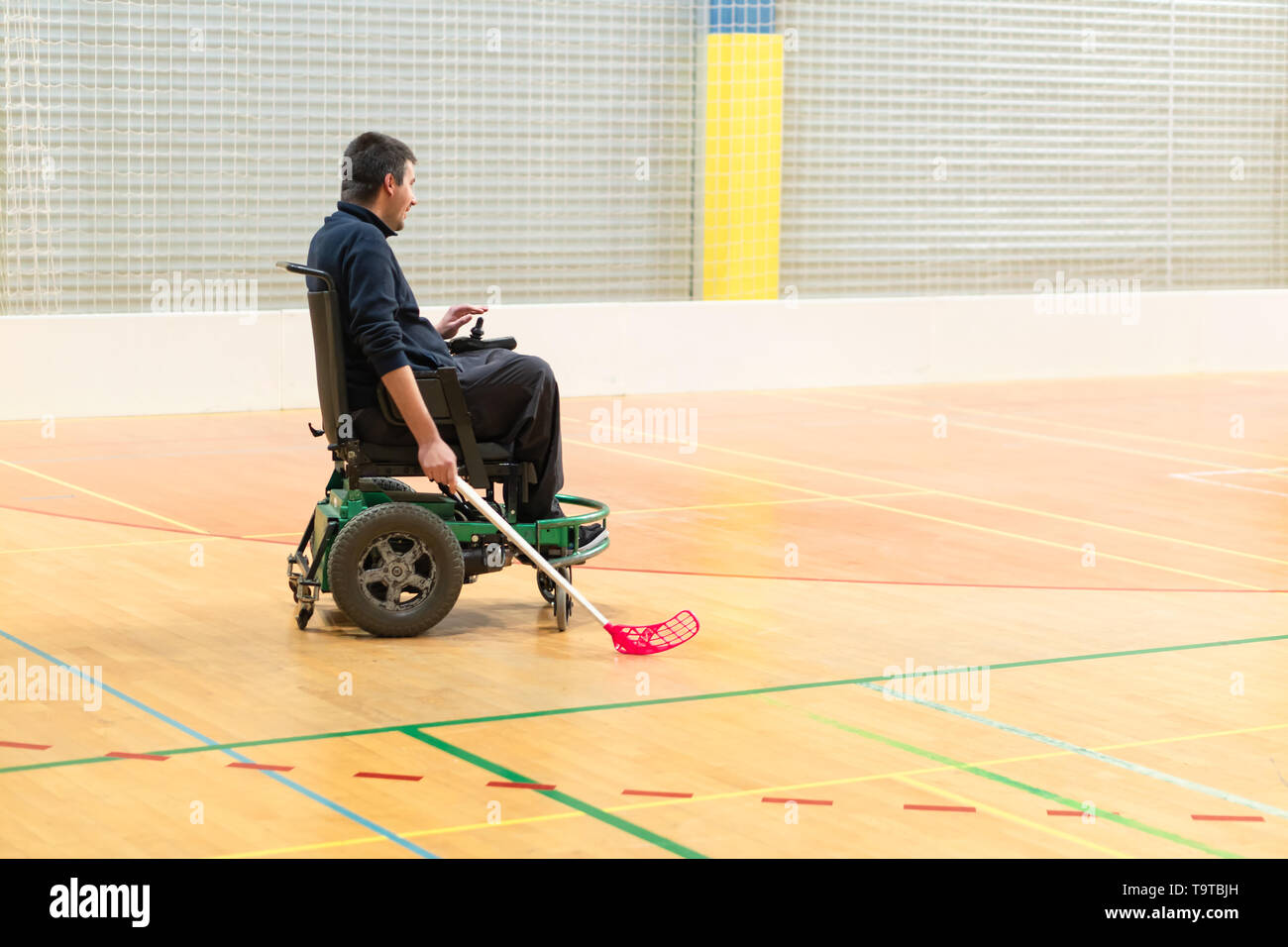 Disabled man on an electric wheelchair playing sports, powerchair ...