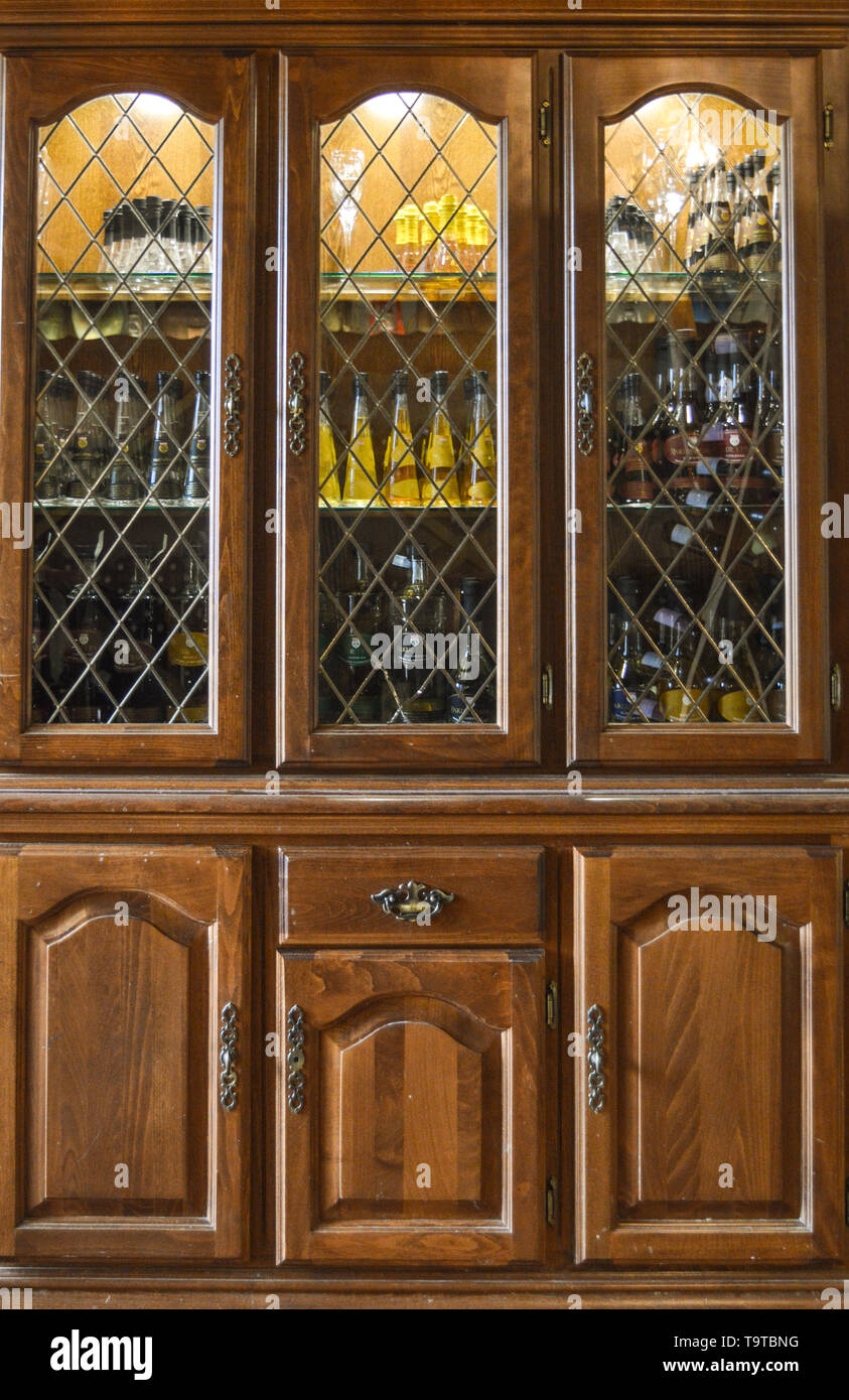 Antique wooden showcase with bottles of liquer Stock Photo - Alamy