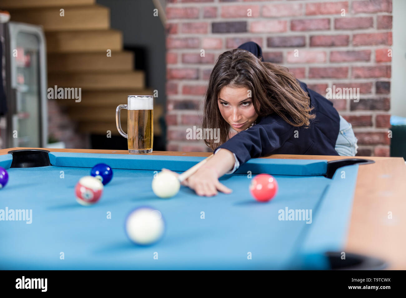 Fashionable modern female playing pool table billiards game Stock Photo ...