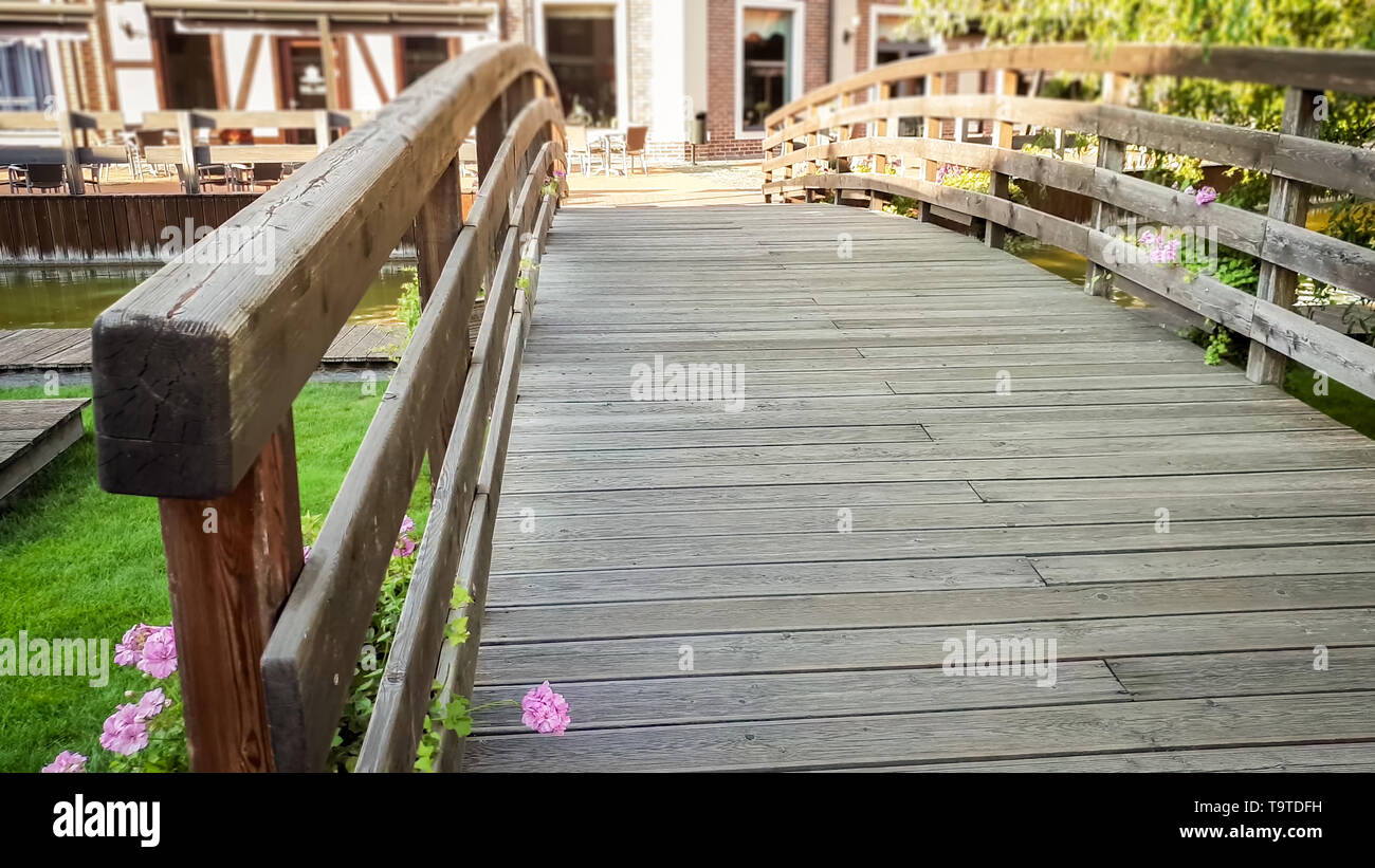 Beautiful toned image of small wooden bridge across river in european ...