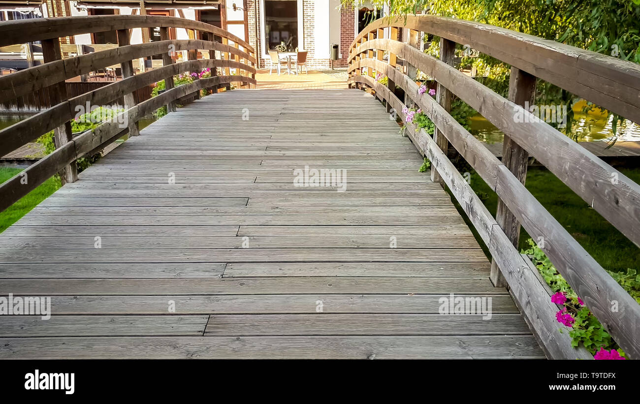 Beautiful toned image of small wooden bridge across river in european ...