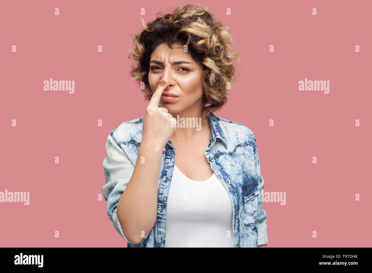 You are liar. Portrait of serious young woman with curly hairstyle in ...