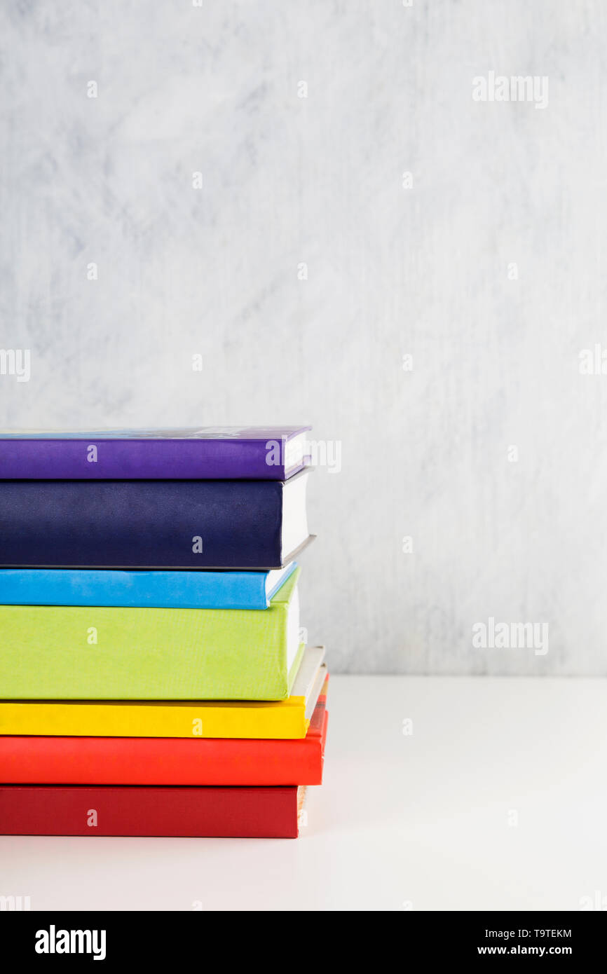 Stack of colorful rainbow books on white background. Copy space Stock ...