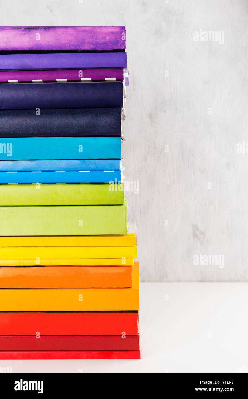 Stack of colorful rainbow books on white background. Copy space Stock ...