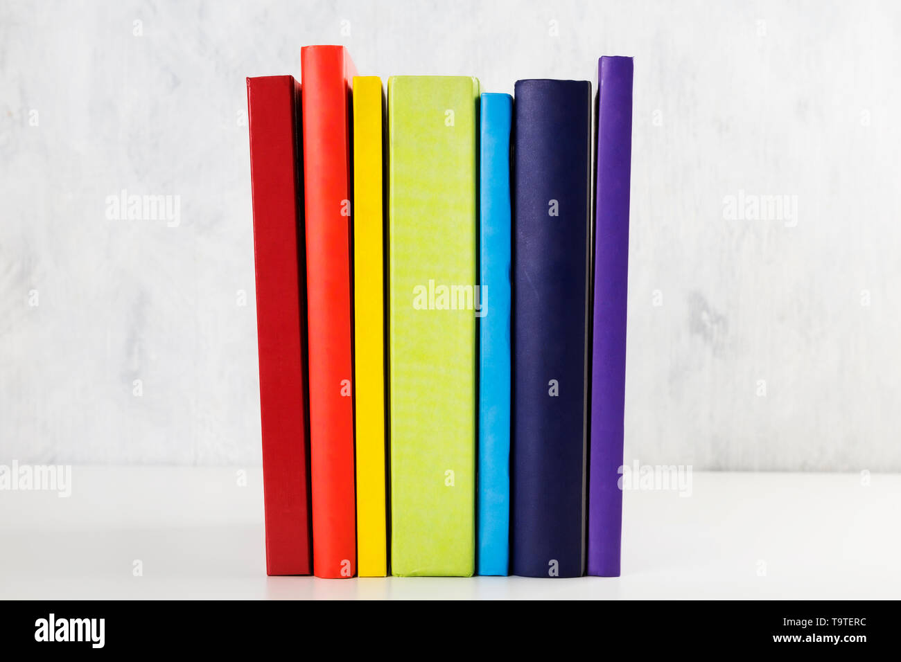 Stack of colorful rainbow books on white background Stock Photo - Alamy