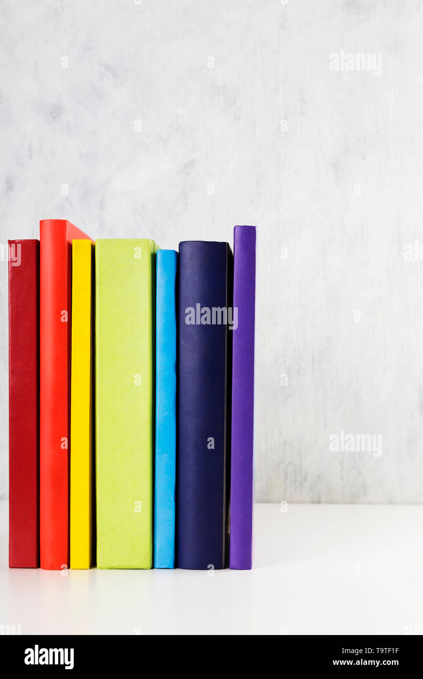 Stack of colorful rainbow books on white background. Copy space Stock ...