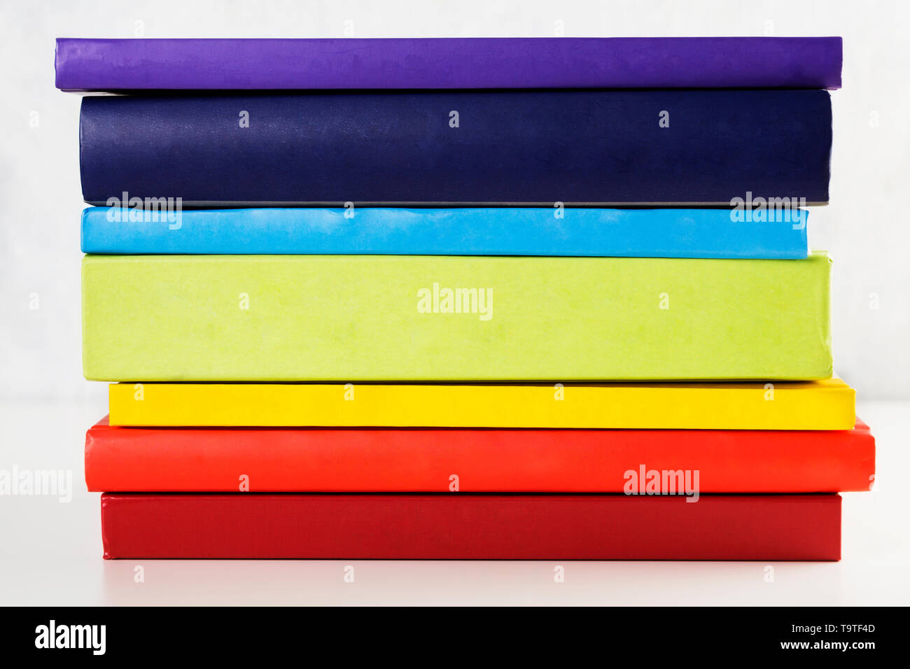Stack of colorful rainbow books on white background Stock Photo - Alamy
