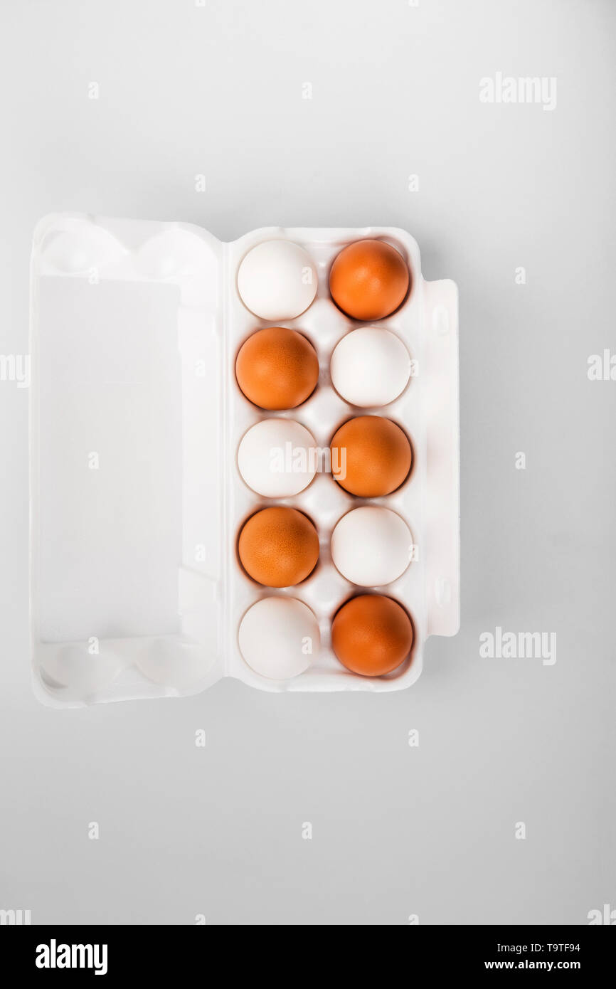 Group of raw eggs white and brown. Concept of diversity, isolation ...