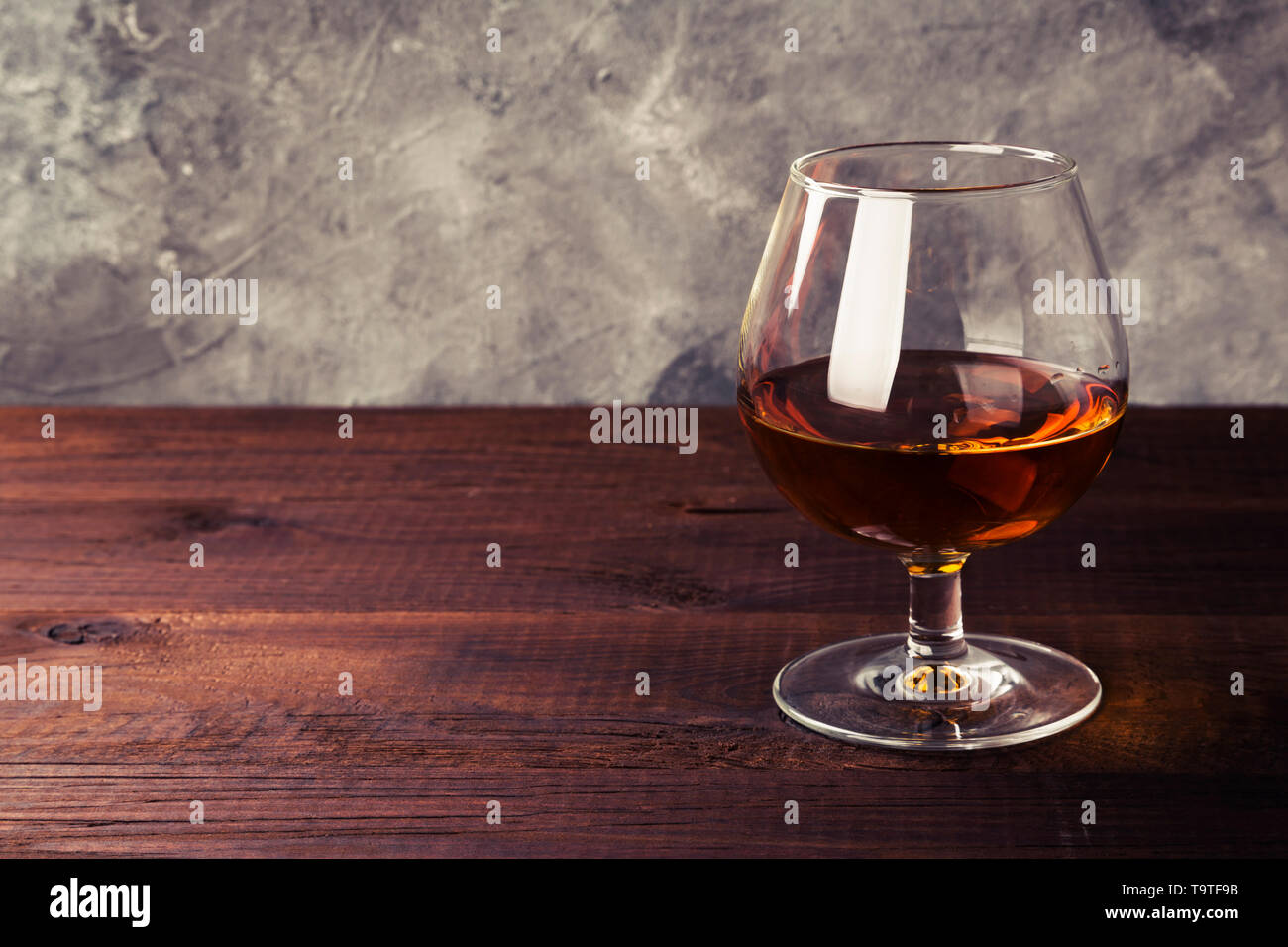Cognac in glass on wooden background. Copy space. Food background ...