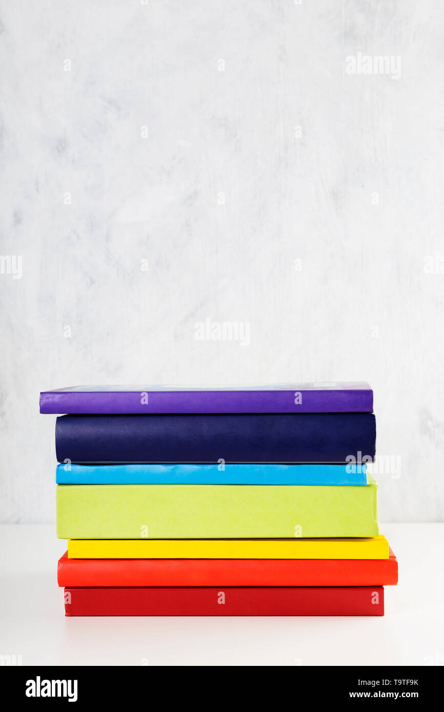 Stack of colorful rainbow books on white background. Copy space Stock ...