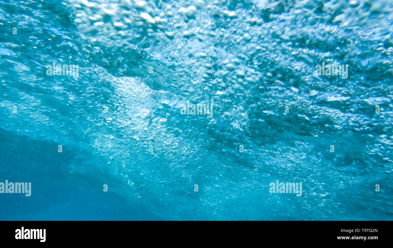 Closeup image of air bubbles in sea water. Shot from the inside of ...