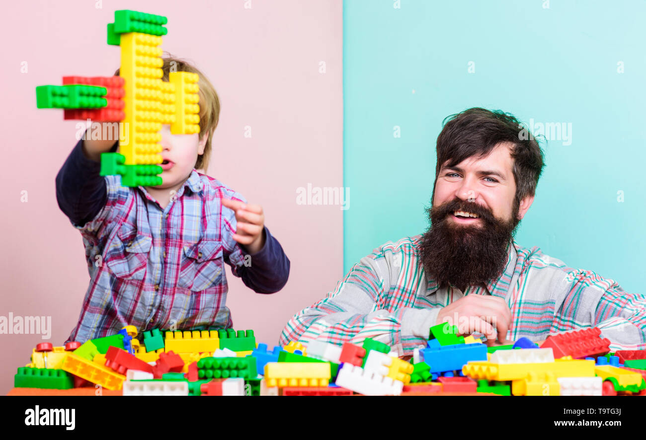 Father son create constructions. Father and boy play together. Dad and ...