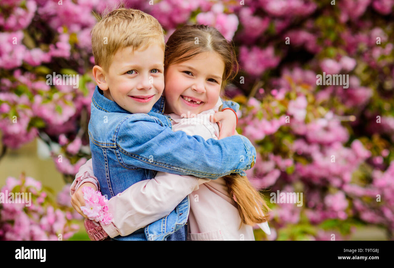 Love is in the air. Romantic babies. Couple kids walk sakura tree ...