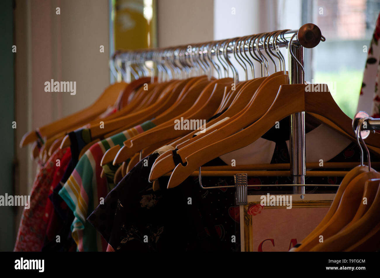 Image of retail location, clothes hanging on display Stock Photo - Alamy