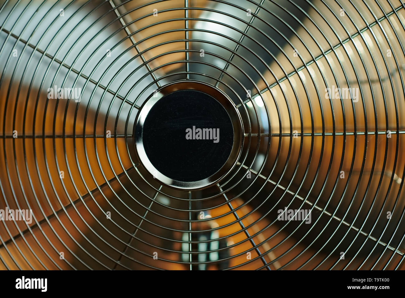 Closeup on electric metallic fan in the modern house in sunny hot ...
