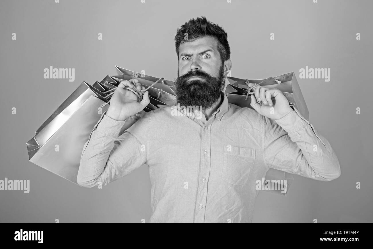 Man searching for cool items, holiday rush concept. Bearded man in pink ...