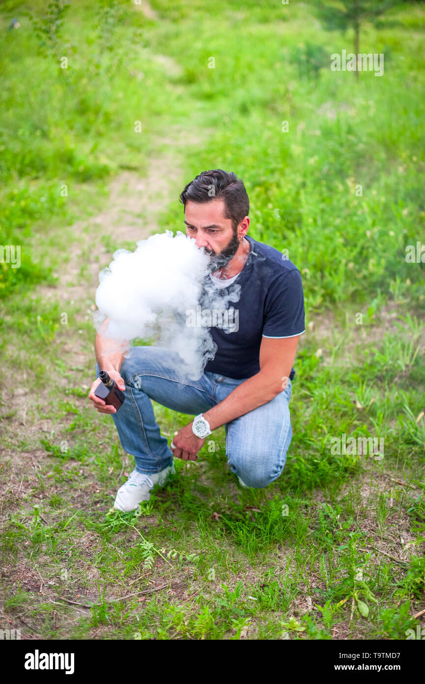 Modern smoker smoking an electronic smoke device. Vape Stock Photo - Alamy