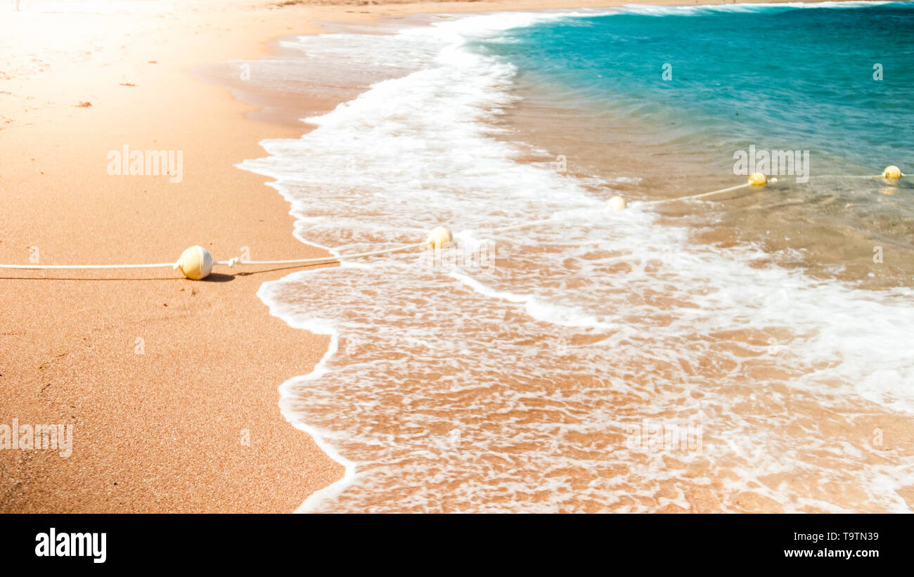Closeup photo of floating buoys line on rope floating in sea Stock ...