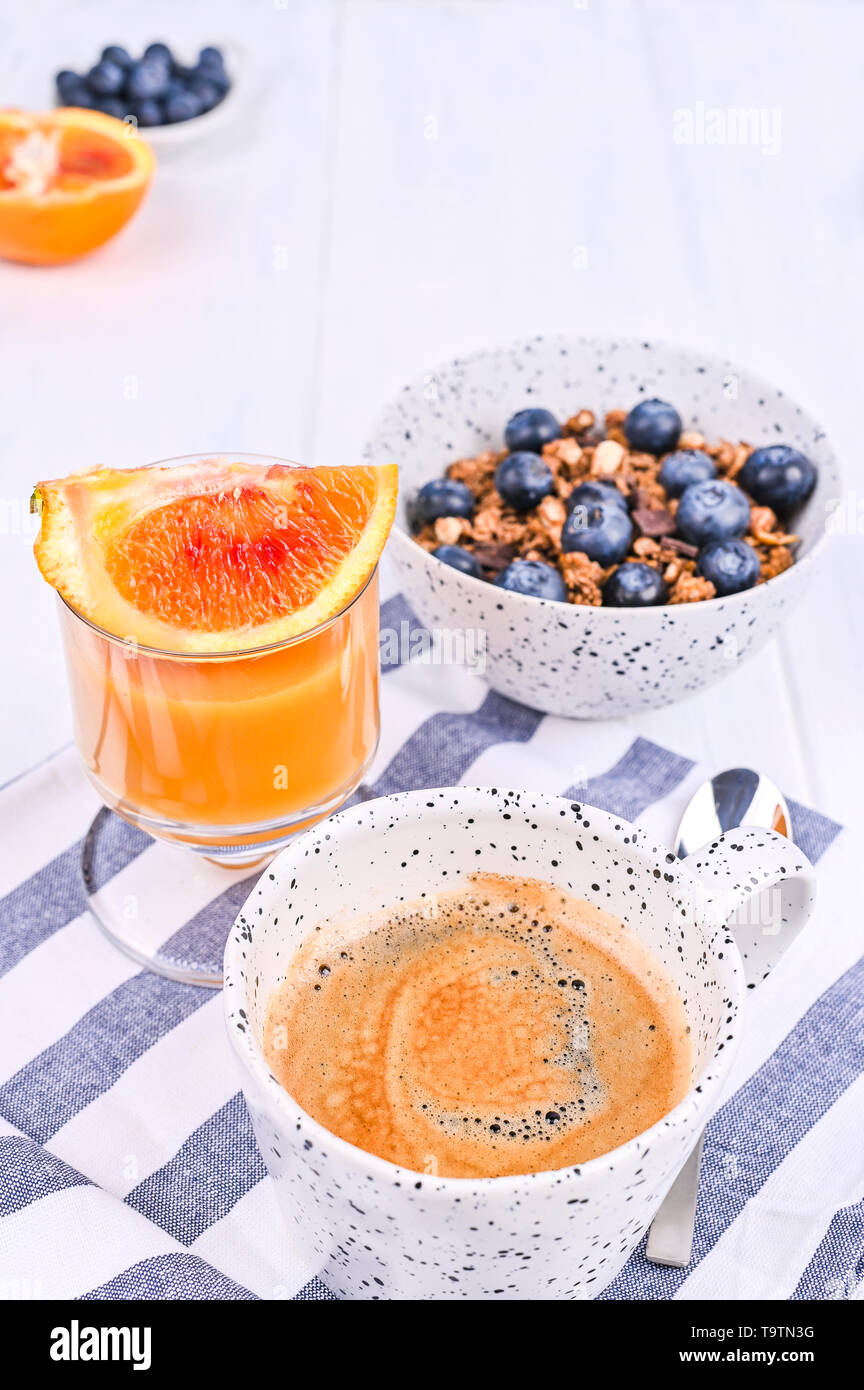 Traditional european breakfast on white wooden background. Muesli with ...