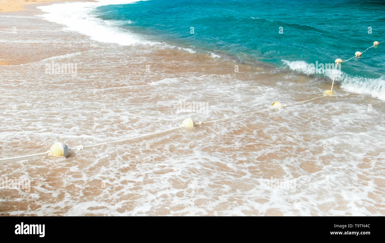 Closeup photo of floating buoys line on rope floating in sea Stock ...