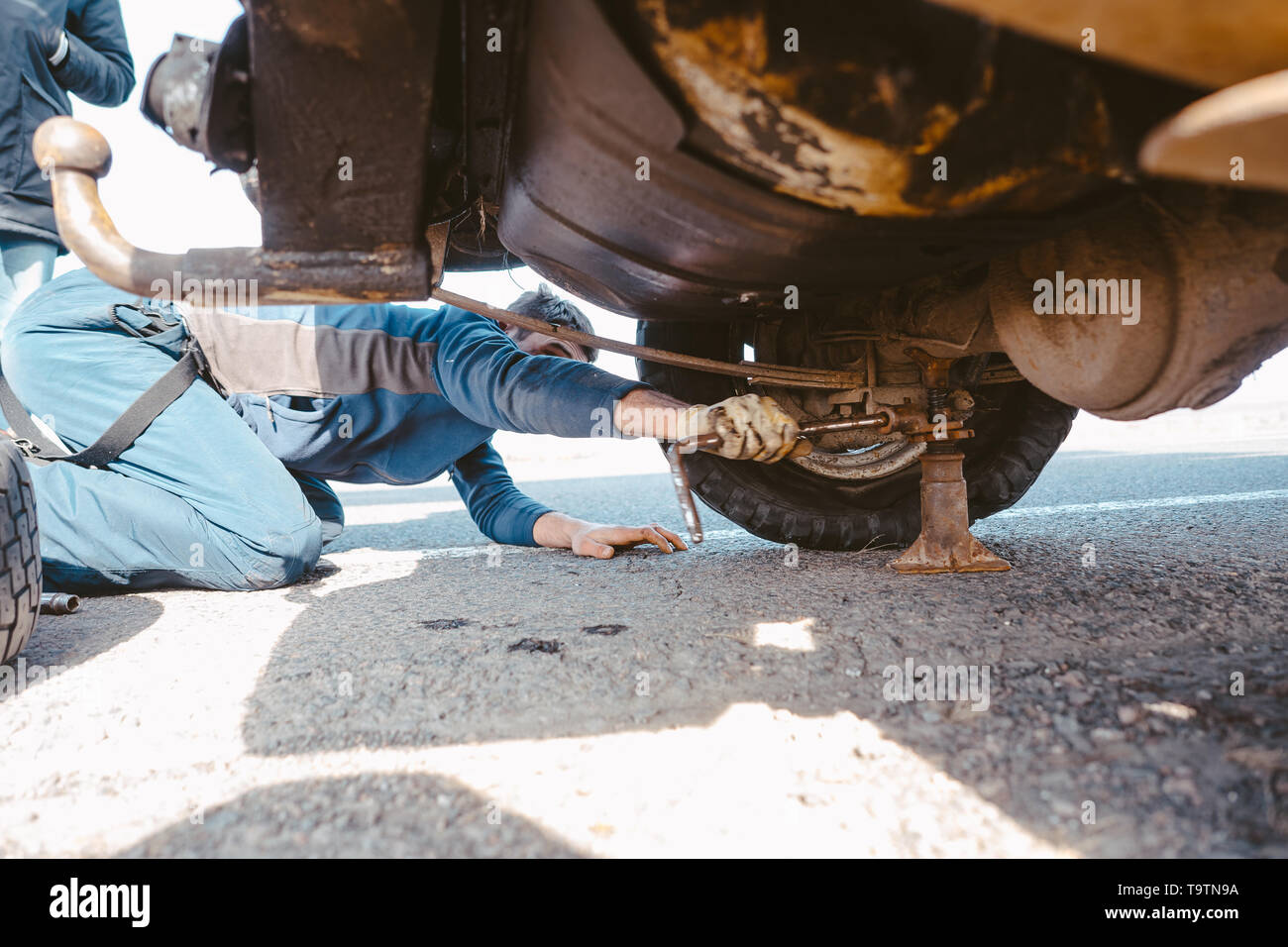 Man lying under car hi-res stock photography and images - Alamy