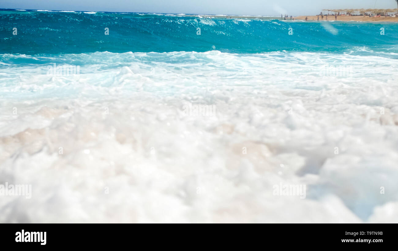 Closeup image of sea waves rolling over the coast. Ocean tides crushing ...