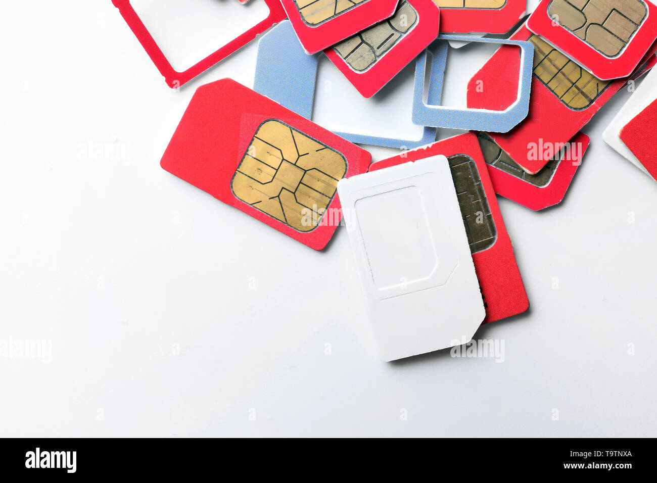 Many sim cards on white background Stock Photo - Alamy