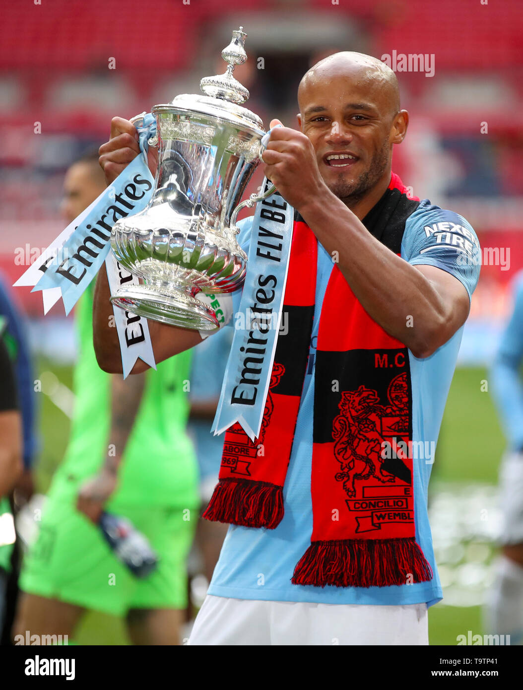Manchester City's Vincent Kompany lifts the trophy after his side win ...