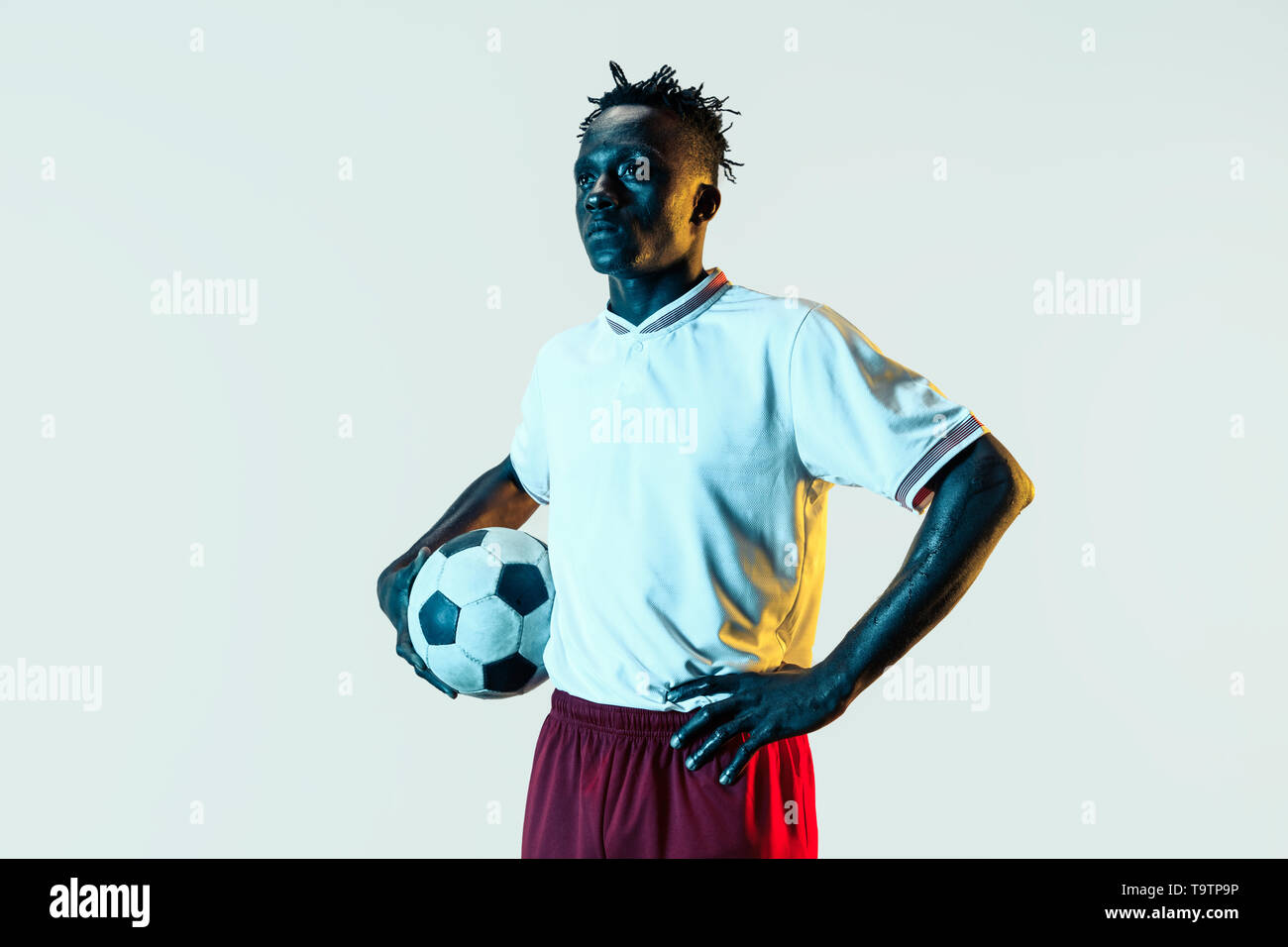 Young african-american male football or soccer player in sportwear and ...
