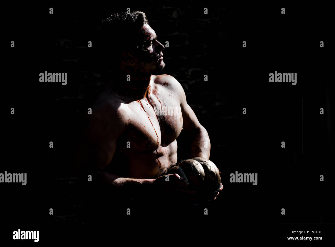 Halloween Man With Zombie Face And Muscular Body Hold Pumpkin Stock