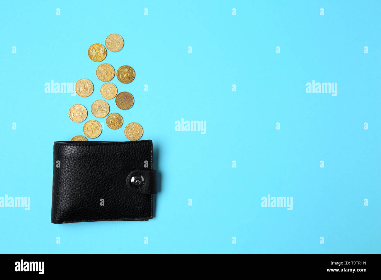 Wallet and coins on color background Stock Photo - Alamy