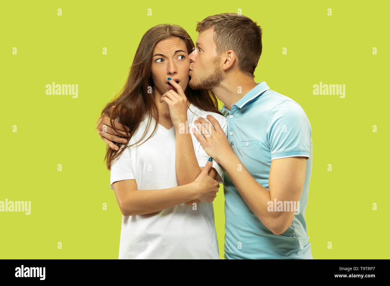 Beautiful young couple's half-length portrait isolated on green studio ...