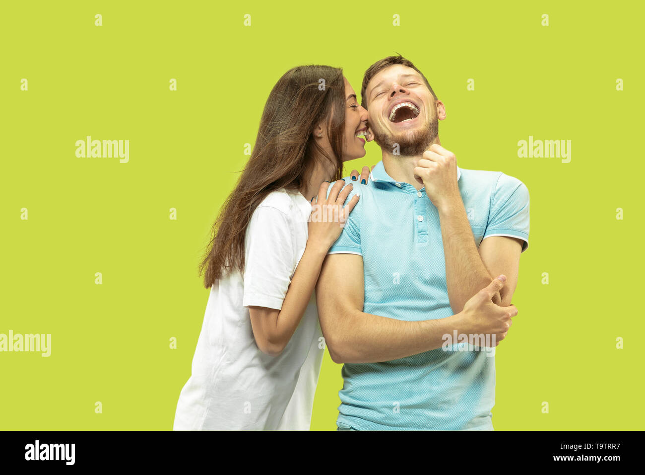 Beautiful young couple's half-length portrait isolated on green studio ...