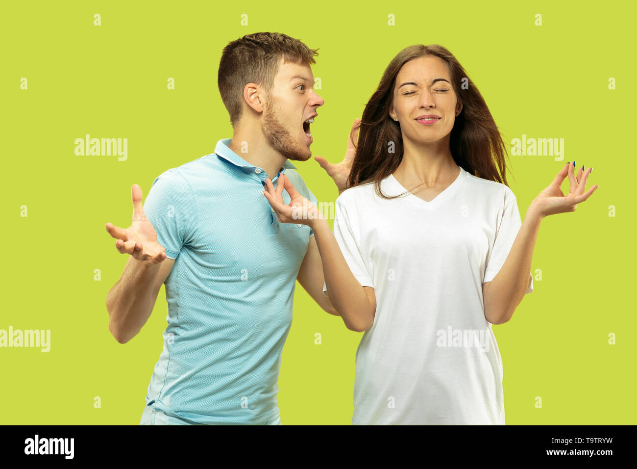 Beautiful young couple's half-length portrait isolated on green studio ...