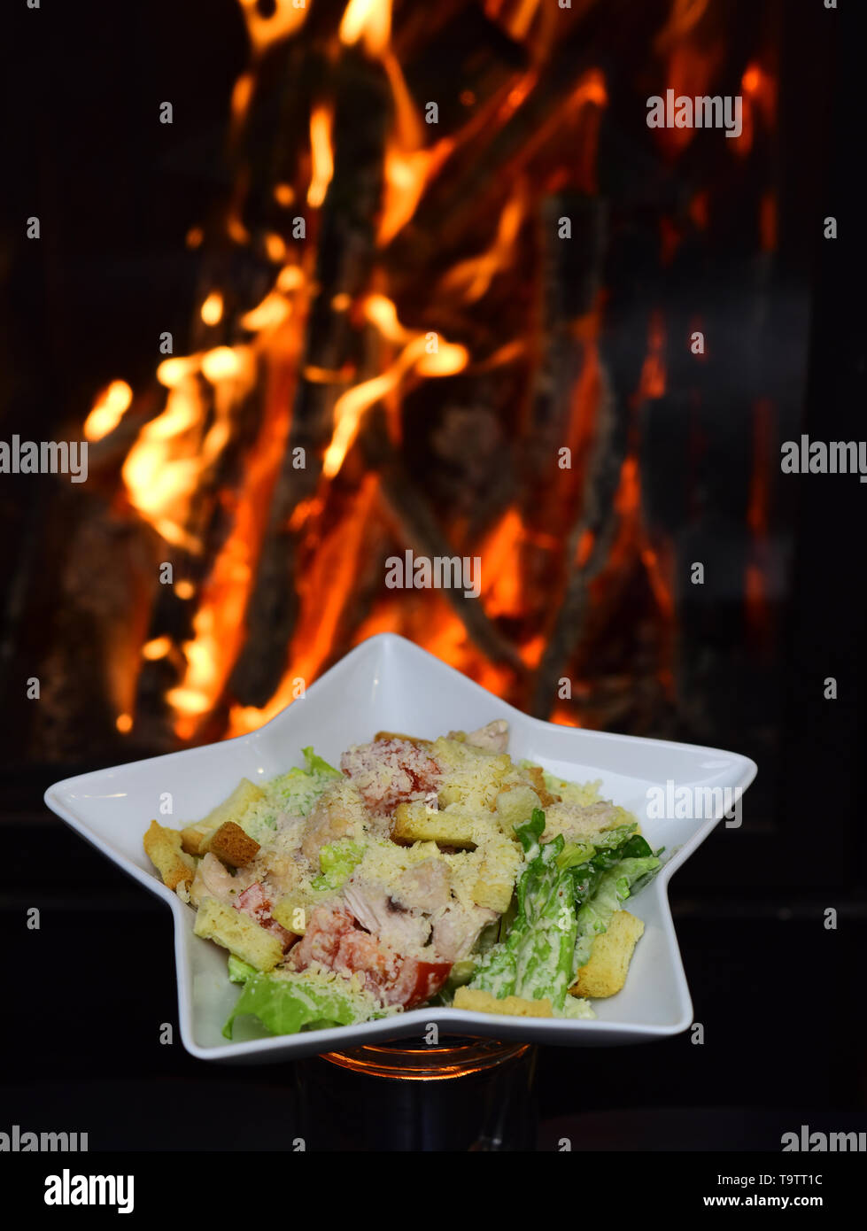 Serving shicken salad for healthy diet on burning flame background ...