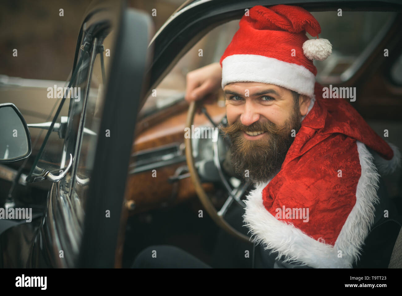 Santa Claus driver smiling at wheel Stock Photo - Alamy