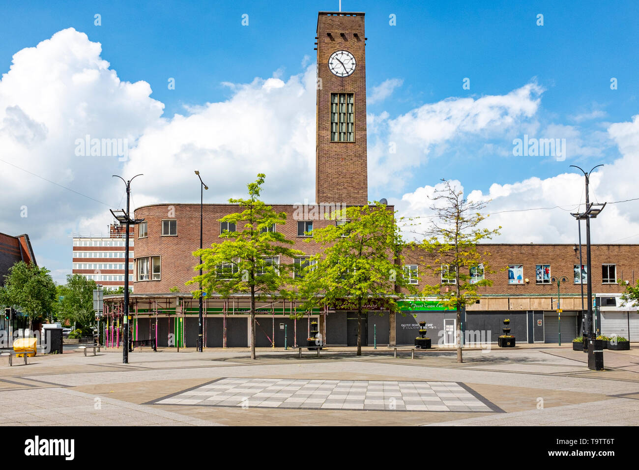 Boarded up shops with clock tower and foundation of removed war ...