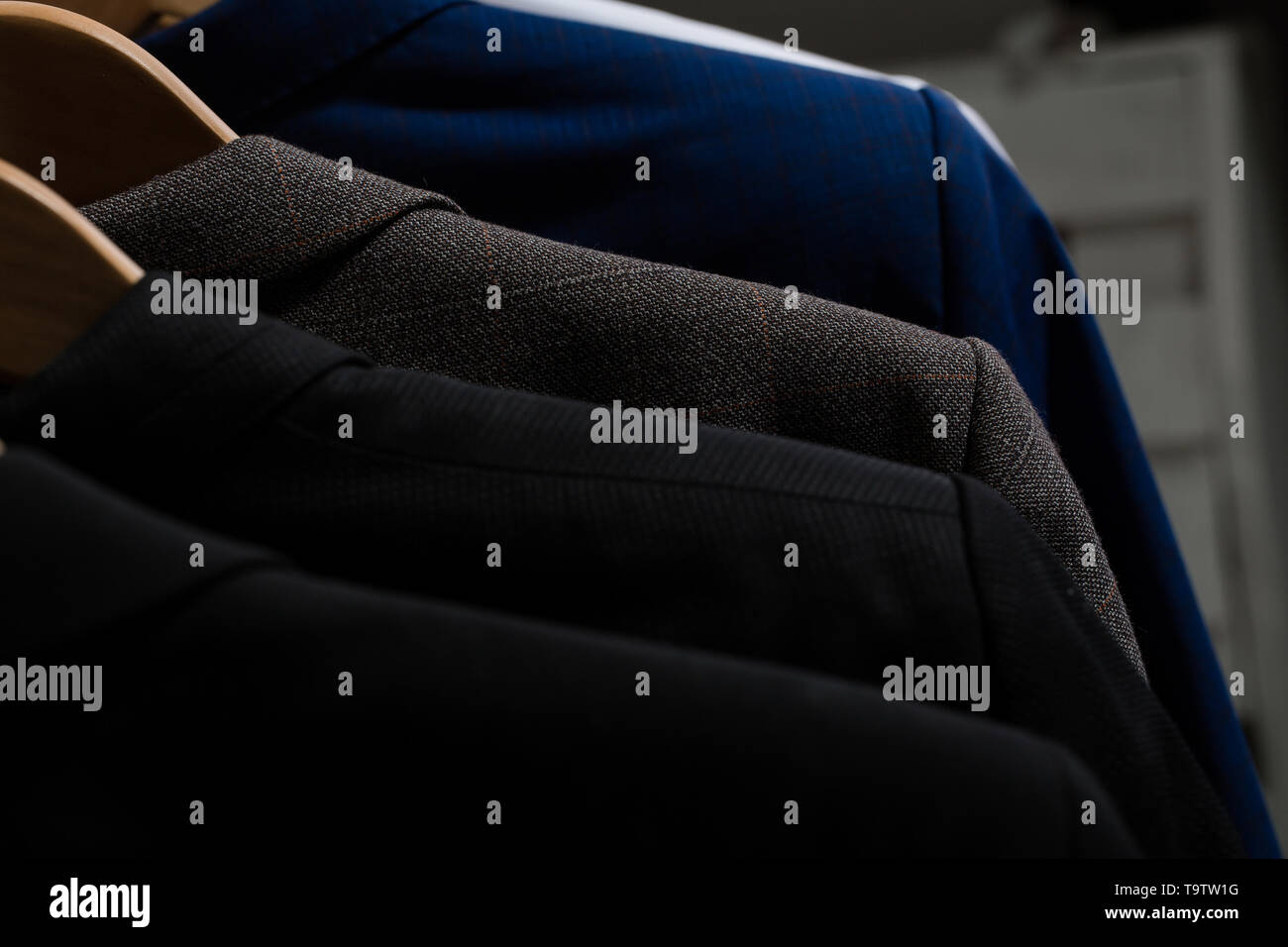 Collection of formal jackets on hangers on blurred background Stock ...