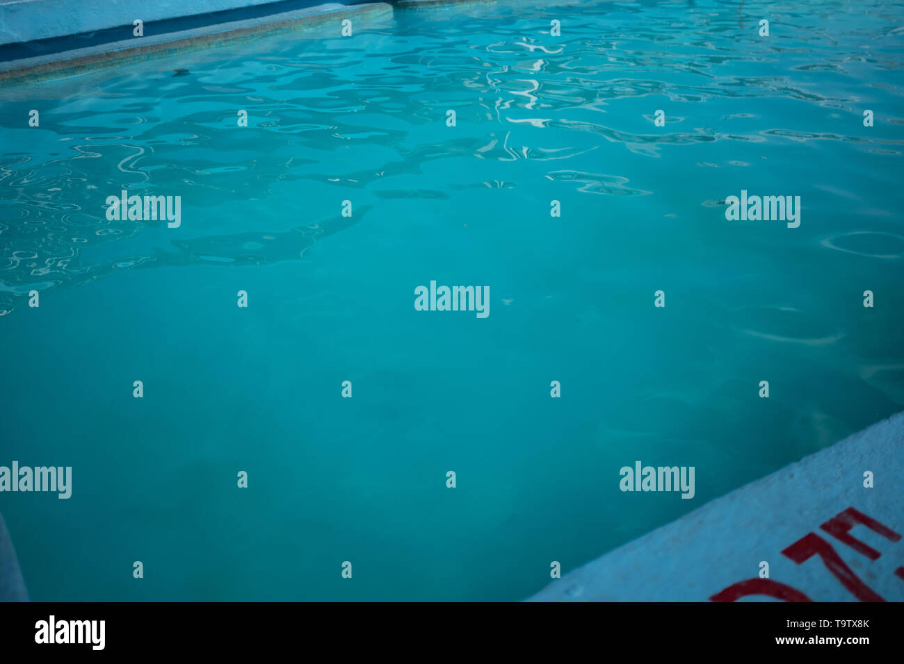 Cool blue swimming pool with ripples on the water's surface Stock Photo ...