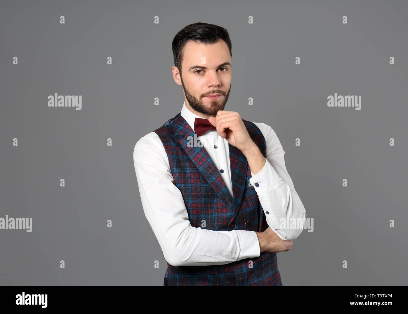 Fashionable young man in formal clothes on grey background Stock Photo ...