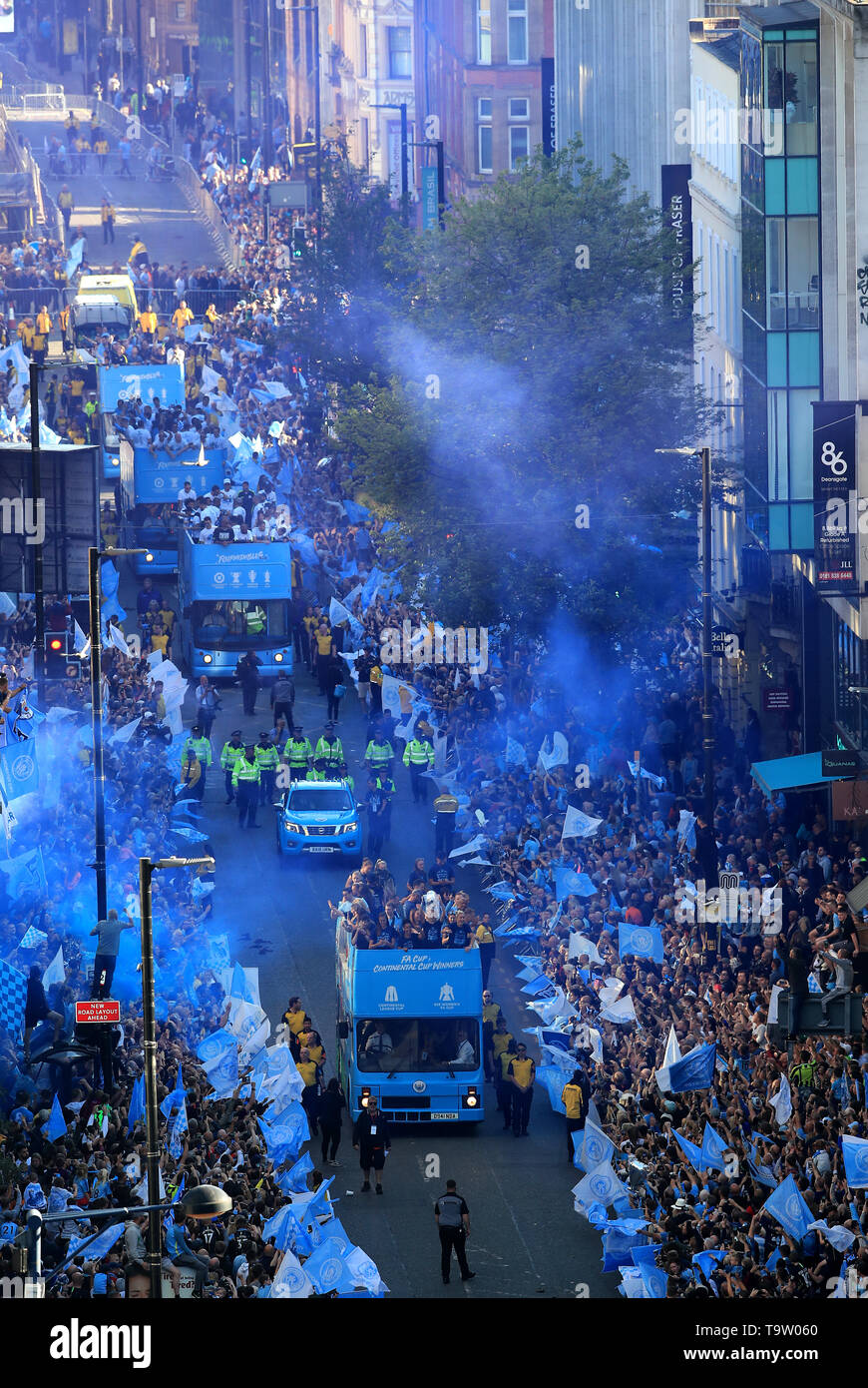The players and staff on the buses pass the crowds of fans during the ...