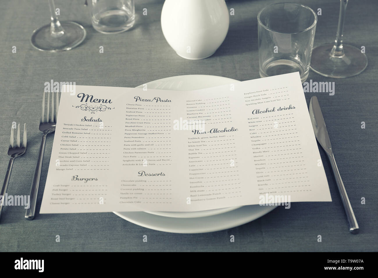 Menu on served table in restaurant Stock Photo - Alamy