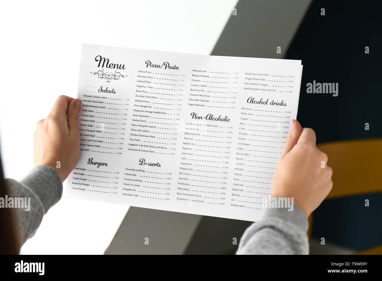 Woman reading menu in cafe Stock Photo - Alamy