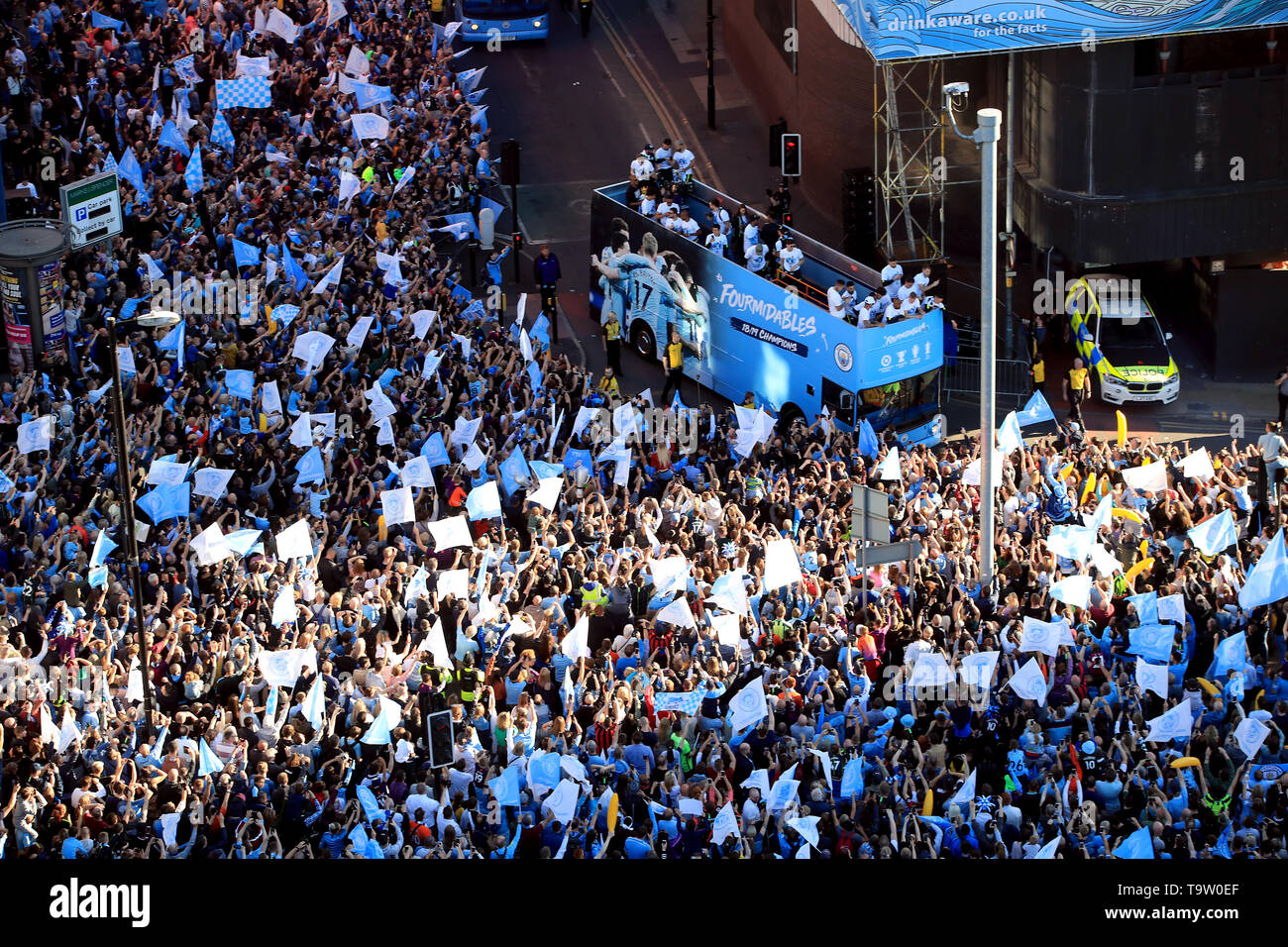 The Manchester City players and staff on the buses pass the crowds of ...