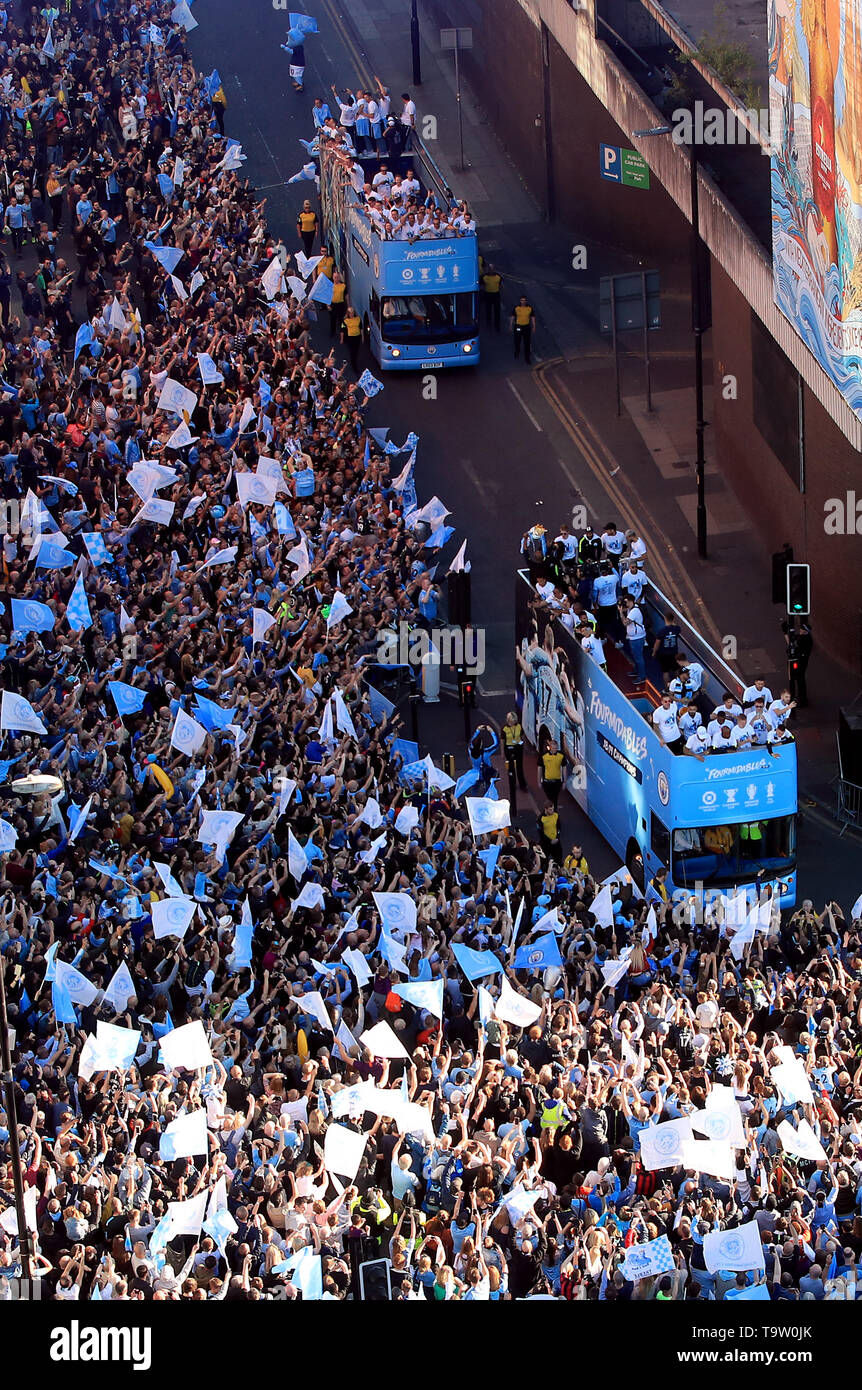 The Manchester City players and staff on the buses pass the crowds of ...