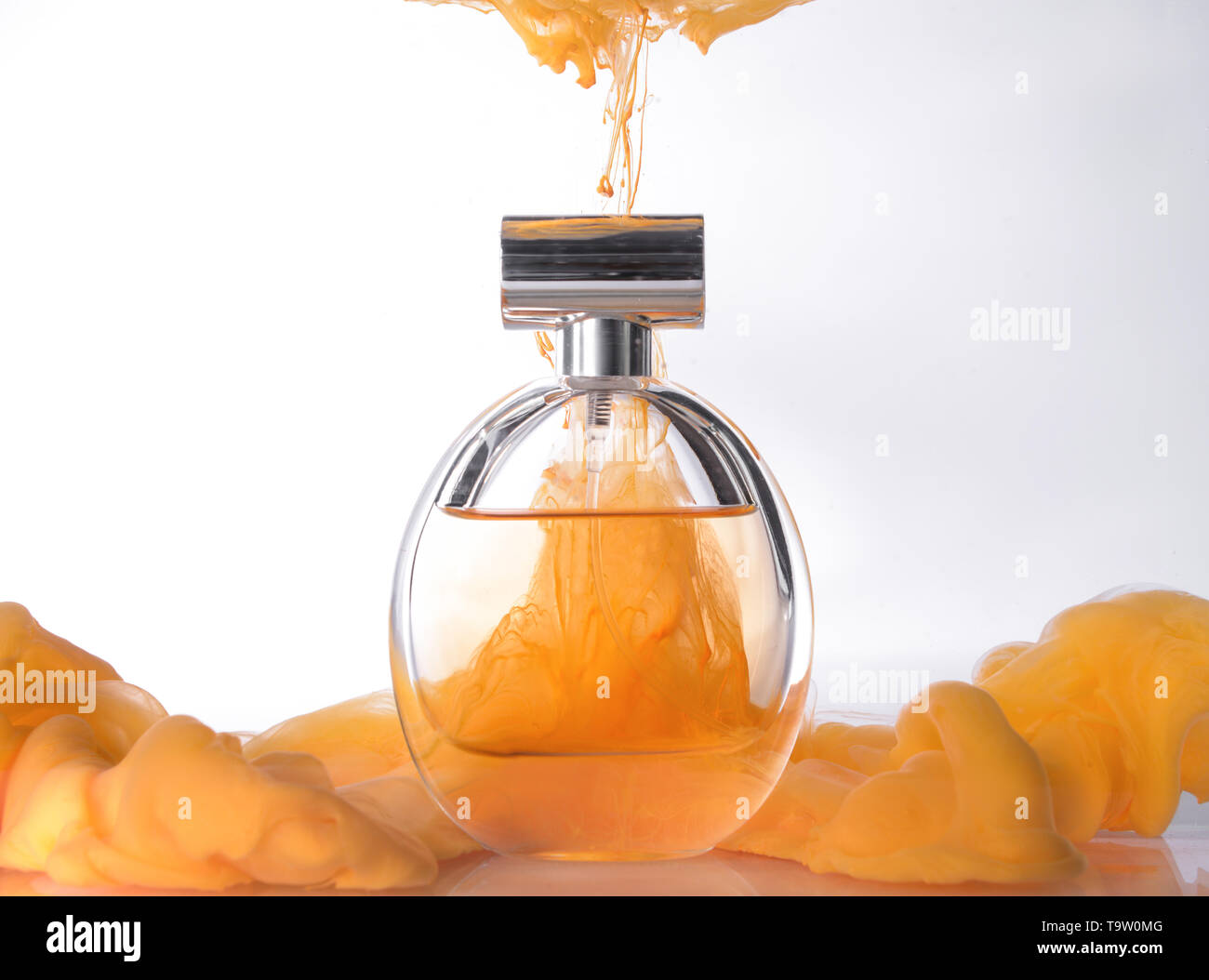 Bottle of perfume in color smoke on white background Stock Photo - Alamy