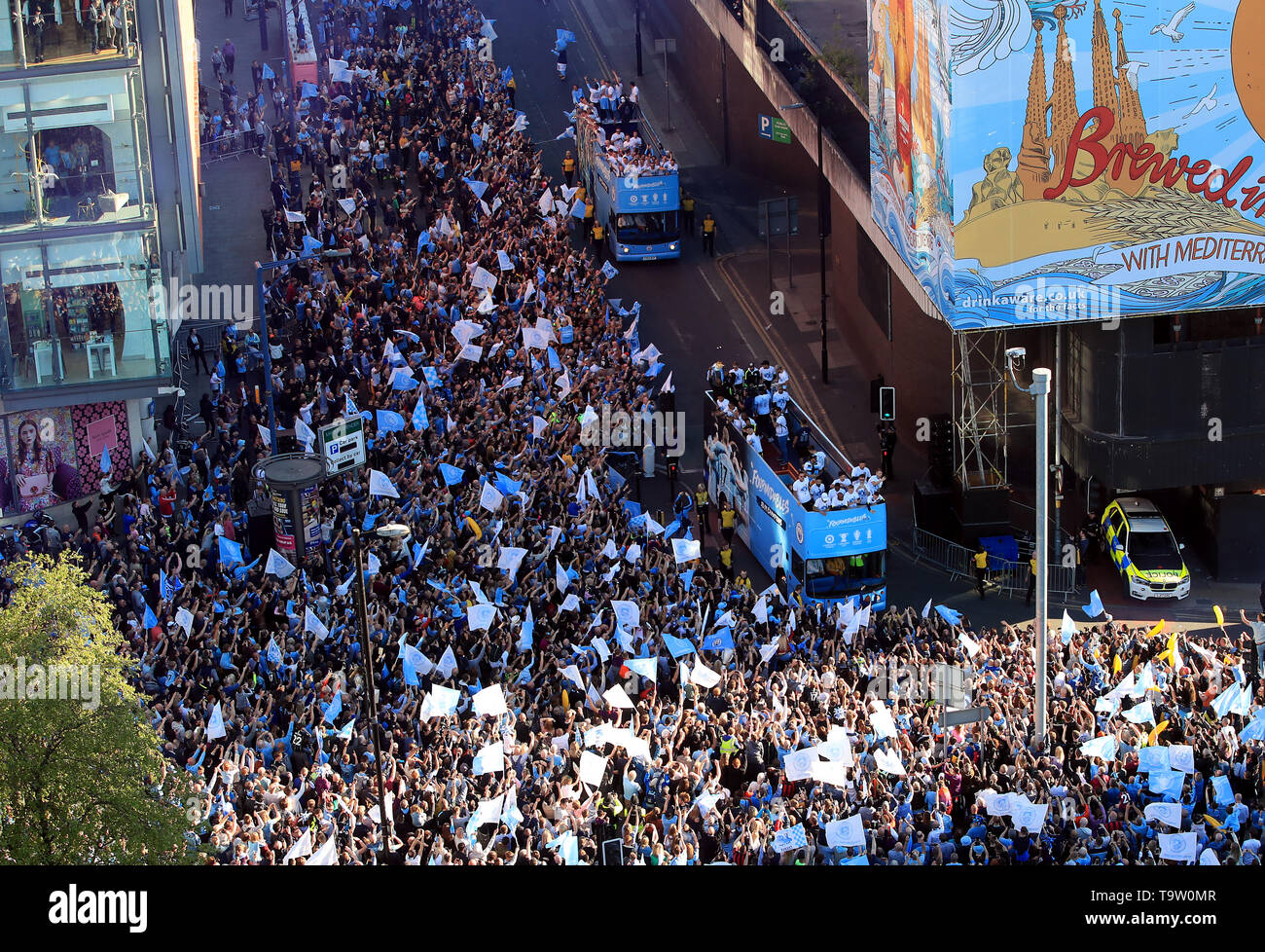 The Manchester City players and staff on the buses pass the crowds of ...