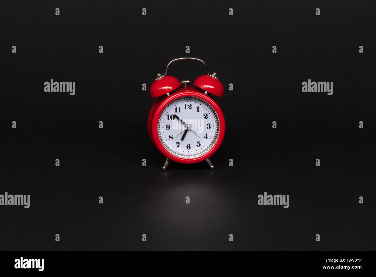 red alarm clock on black background, isolated Stock Photo - Alamy