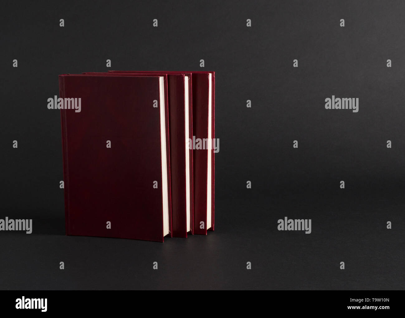 books with red cover on black background, isolated. back to school ...